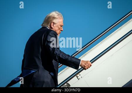 President Donald Trump boards Air Force One for a trip to Detroit ...