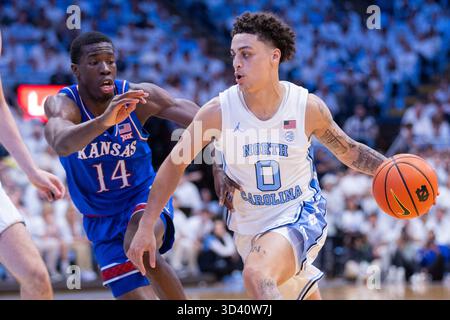 North Carolina guard Kyan Evans (0) drives against Navy forward Mike ...