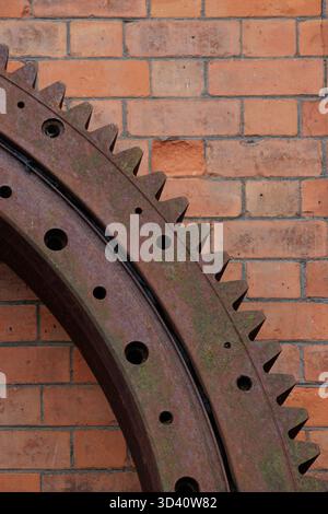 Large rusty industrial metal cog wheel and red brick wall Stock Photo ...