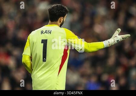 Arsenal goalkeeper David Raya gives his match shirt to a fan during the ...