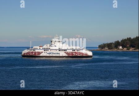A ferry sails through Victoria Harbor Hong Kong, Hong Kong S.A.R ...