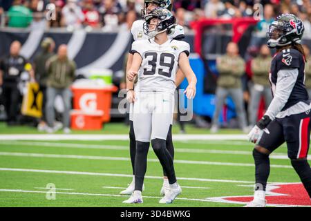 Jacksonville Jaguars place kicker Cam Little (39) kicks an extra point ...