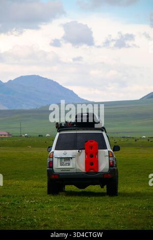 White SUV Car with the roof rack cargo box on road in Untertauern ...