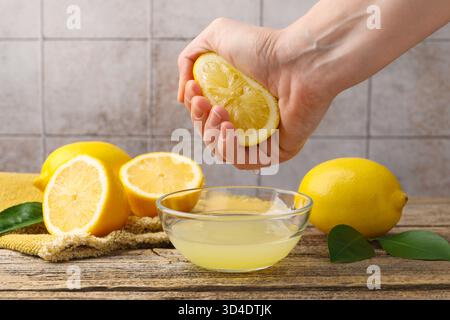 Woman squeezing juice from lemon on trout on restaurant terrace Stock ...