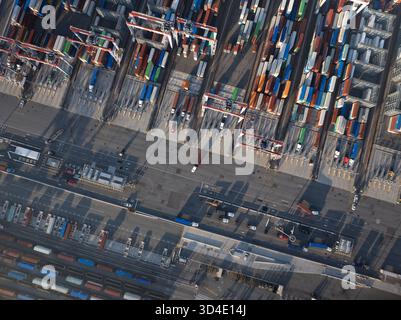 Long trains with colorful shipping containers and empty flatcars in a ...