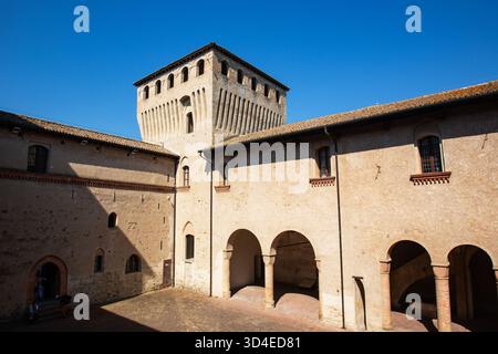A serene view of an old Italian castle's inner courtyard featuring a ...