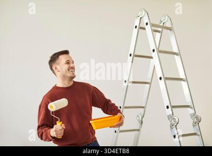 Young painter doing renovation at home Stock Photo - Alamy