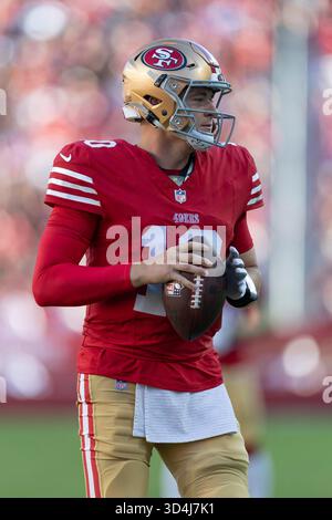 San Francisco 49ers quarterback Mac Jones, left, and running back Brian ...