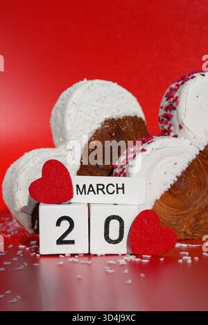 Heart shaped coconut flavor croissant on red background with copy space ...