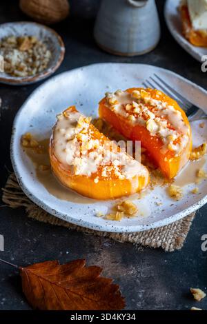 Pumpkin dessert with tahini and walnuts on a white porcelain plate ...