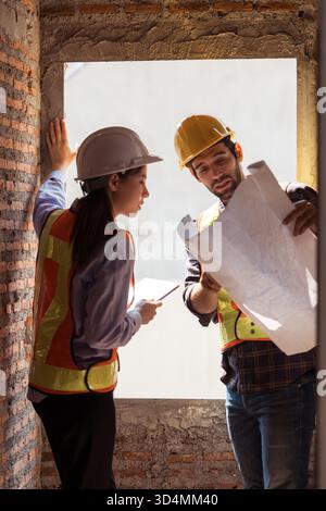 Civil engineers checking work process in construction site Stock Photo ...