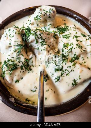 Traditional georgian dish shkmeruli in ceramic bowl Stock Photo - Alamy