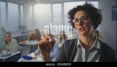 Dynamic Female Teacher With Glasses Writes With Marker Formulas ...