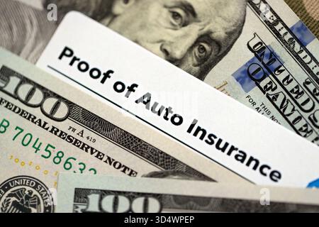 Proof of auto insurance card and many hundred dollar bills. Concept of ...