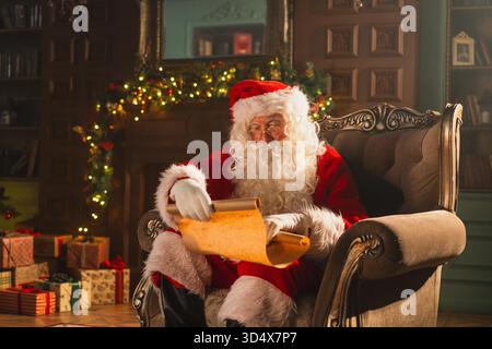 Christmas miracle wish list. Smiling girl in Santa Claus hat and a ...