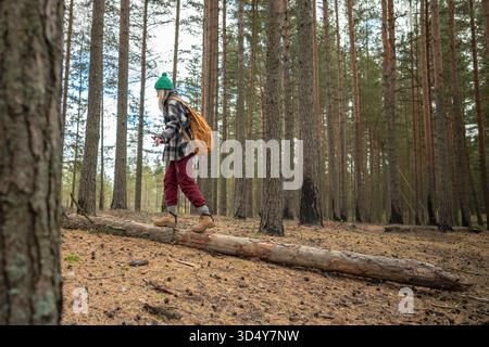 A woman walks by a fallen tree, in Bucharest, Romania, Wednesday July 1 ...