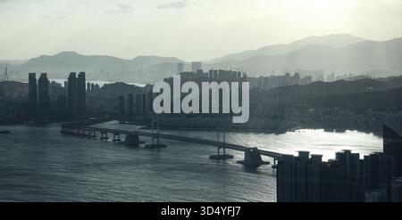 Busan cityscape spanning across mountains and coastline with busy jung ...
