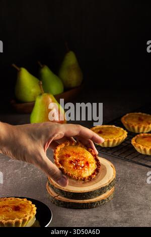 Pear tart on brown wooden rustic table, top view. Copy space, space for ...