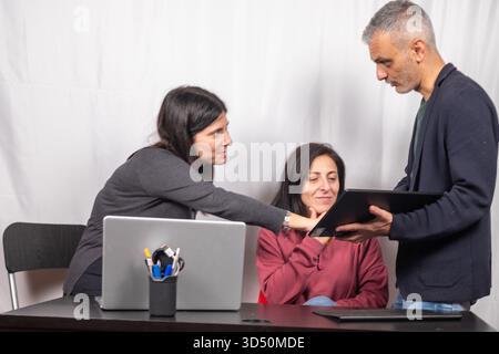 Brainstorming between three colleagues. The two women and the man are ...