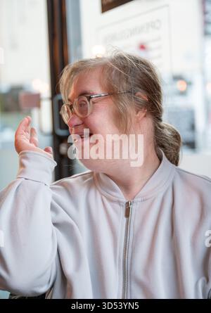 Close-up indoor portrait of a 43-year-old woman with Down syndrome ...