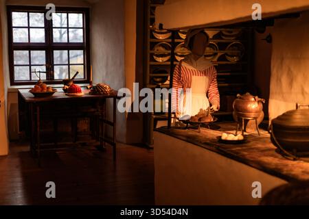 Old castle kitchen with a staged medieval food display on a wooden ...