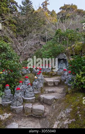 Buddha with red caps at Buddha temple Takifudo island Miyajima ...