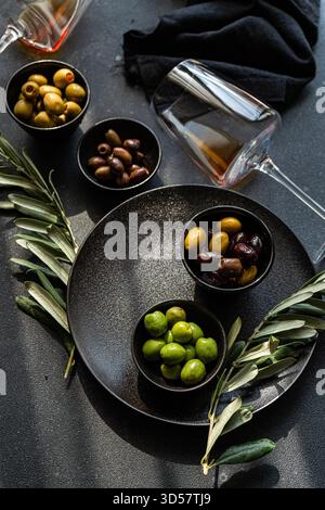 Table setting with Greek olive varieties and Georgian amber wine Stock ...