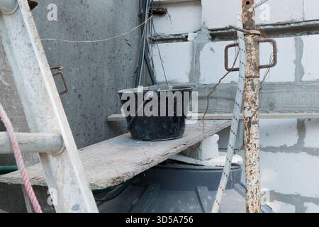 A worker sits on metal pipes at a shop in Mumbai, India on 11 January ...