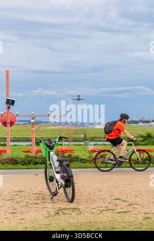 Side view of happy man rides a black kick scooter Stock Photo - Alamy