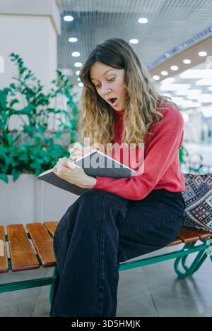Young woman artist expressing creativity by painting on a canvas ...