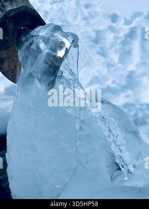 ice crystals form an intricate pattern on inside of glass window during ...