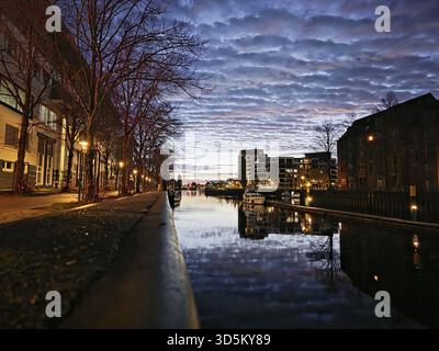 Illuminated building on water at dawn Stock Photo - Alamy
