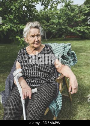 cropped view of woman holding wooden cubes with cfo lettering in office ...