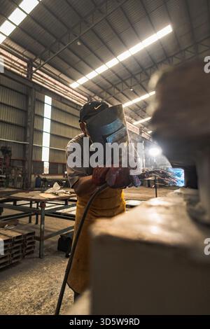 A closeup of a worker welding wearing the welding mask and gloves Stock ...