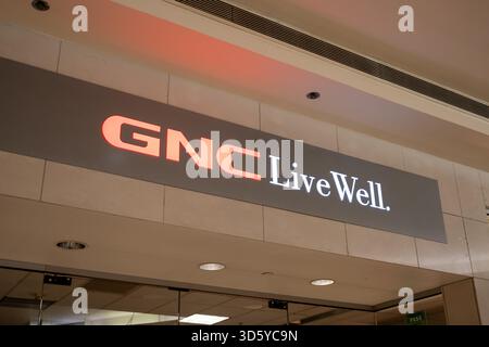 GNC Live Well sign on exterior of commercial building with blue tile ...