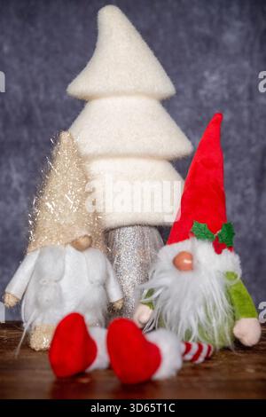Christmas or winter composition. Two gnomes with a bag of gifts in the ...