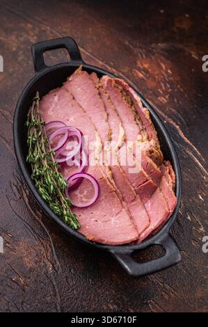 Sliced pastrami arranged on textured ceramic plate against weathered ...