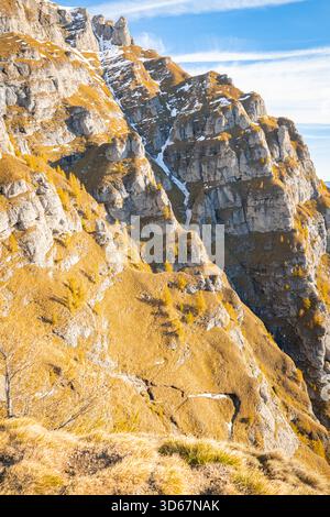 A dramatic landscape featuring jagged mountains soaring above a ...