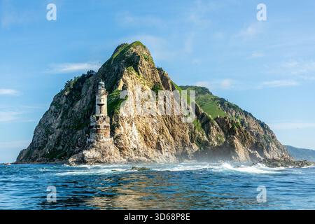 Aniva former japanese lighthouse photographed from sea. Abandoned tower ...
