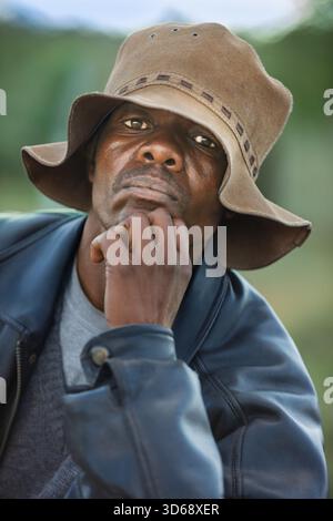 A male farmer sitting in the yard outdoors, resting Stock Photo - Alamy