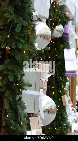 Festive outdoor display of colorful wrapped gift boxes alongside shiny ...