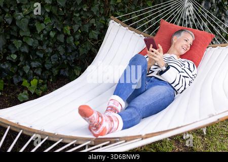 smiling senior woman with fitness tracker at home Stock Photo - Alamy