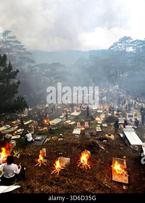 Families light bonfires at the grave of their ancestors at the night of ...