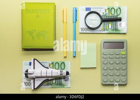 Toy plane, money and calculator on wooden table with copy space. Travel ...