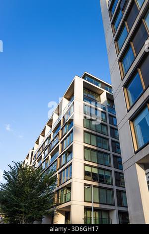 A low-angle view of a contemporary building facade featuring large ...