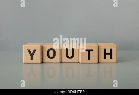 A set of printed cards spelling the word BUGS on an aged wooden ...