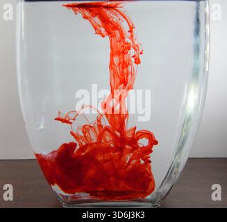 Glass bowl with red food coloring isolated on white Stock Photo - Alamy