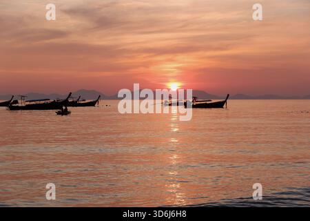 At sunset, the sun colored the sky with shades of pink and red above ...