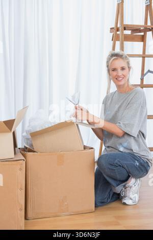 Blonde woman with paint materials Stock Photo - Alamy