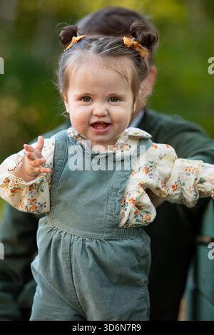 Portrait of happy cute brunette child girl on in summer park outdoors ...